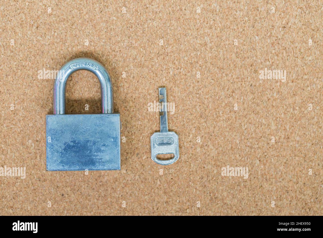 Old master key and key lock on cork board background Stock Photo - Alamy