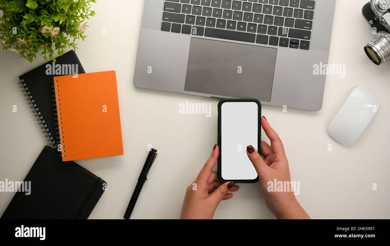 Top view, A female using smartphone on her modern office desk. phone ...