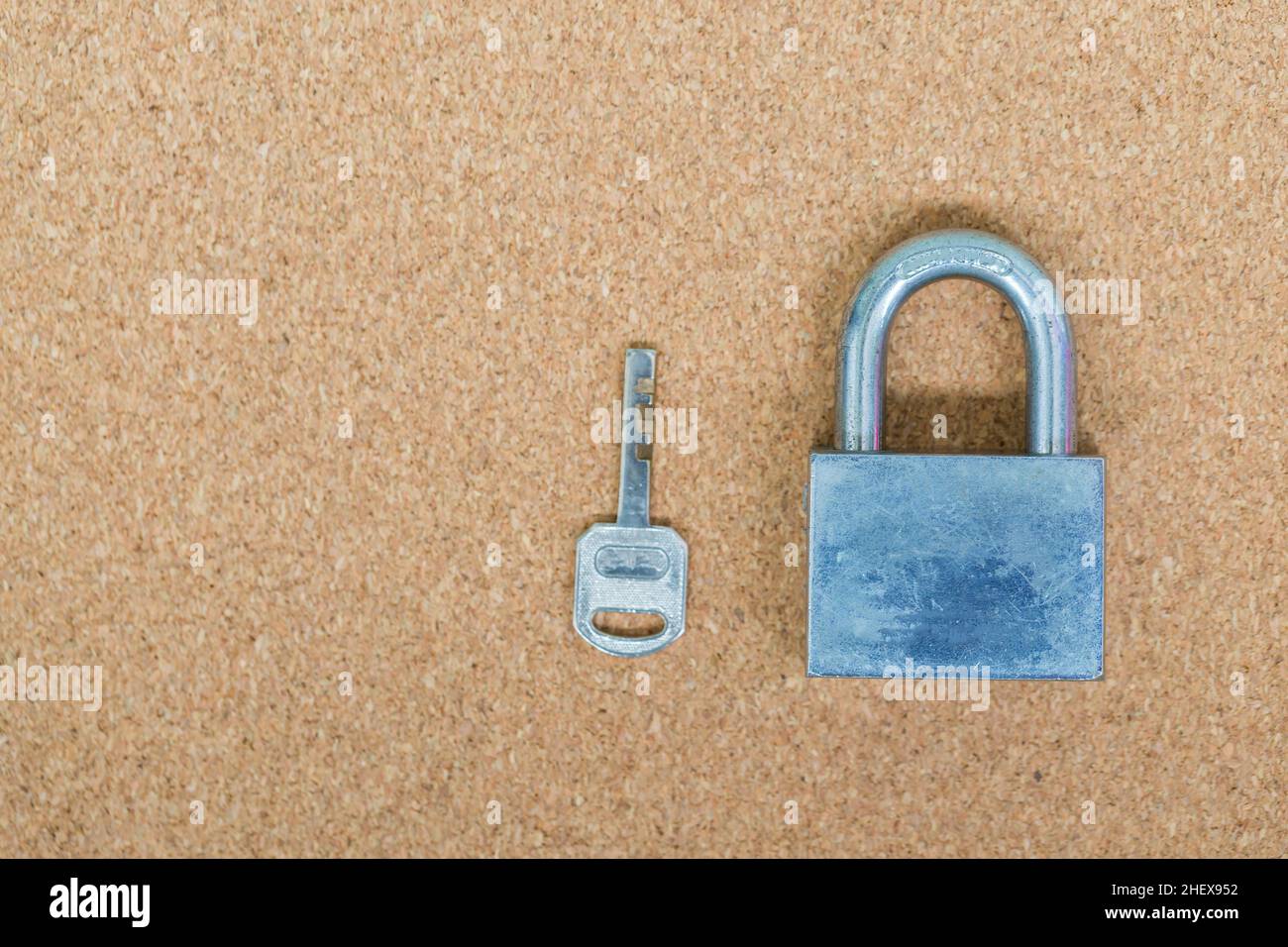 Old master key and key lock on cork board background Stock Photo - Alamy