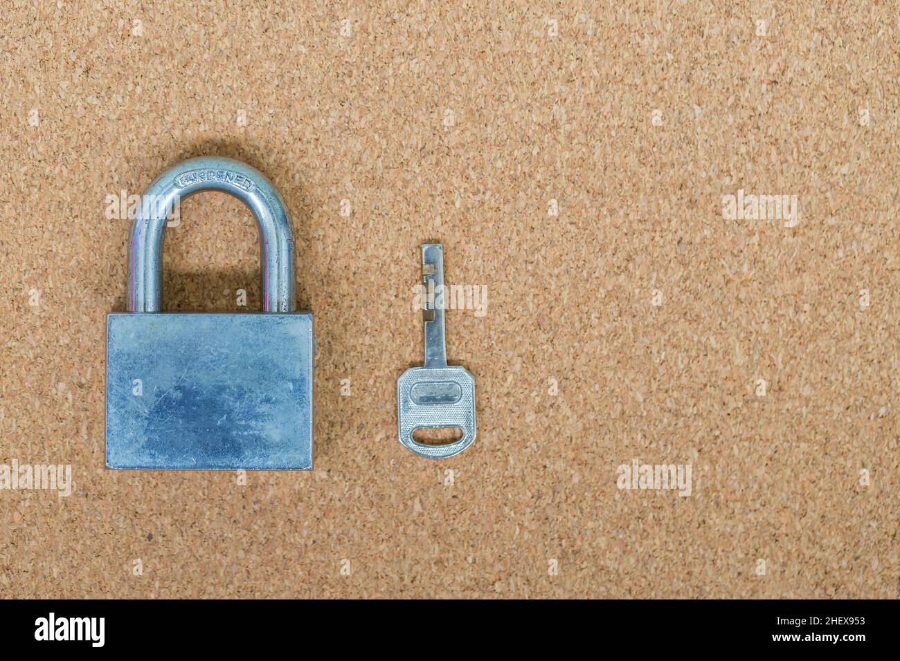 Old master key and key lock on cork board background Stock Photo - Alamy