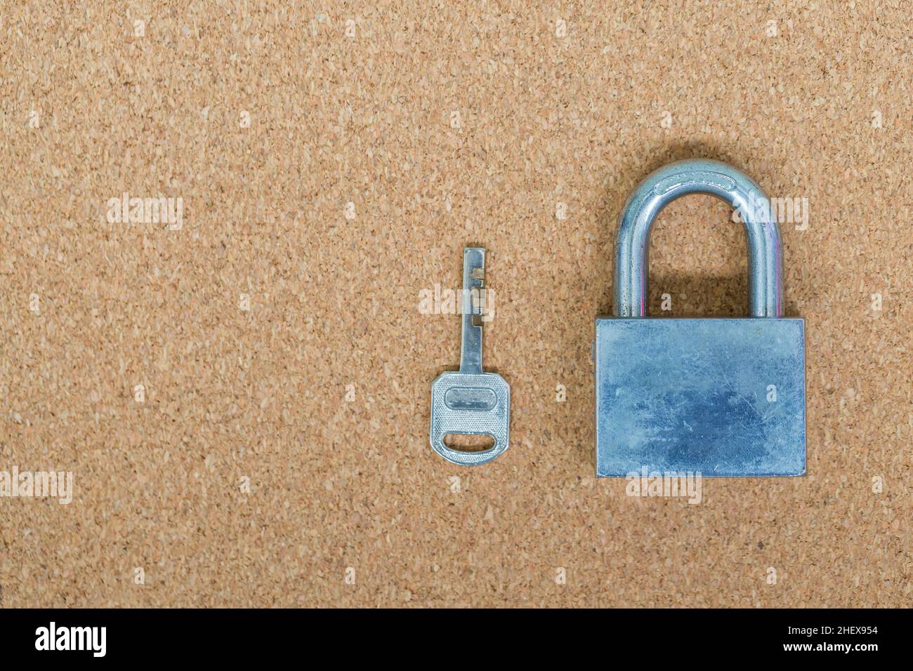Old master key and key lock on cork board background Stock Photo - Alamy