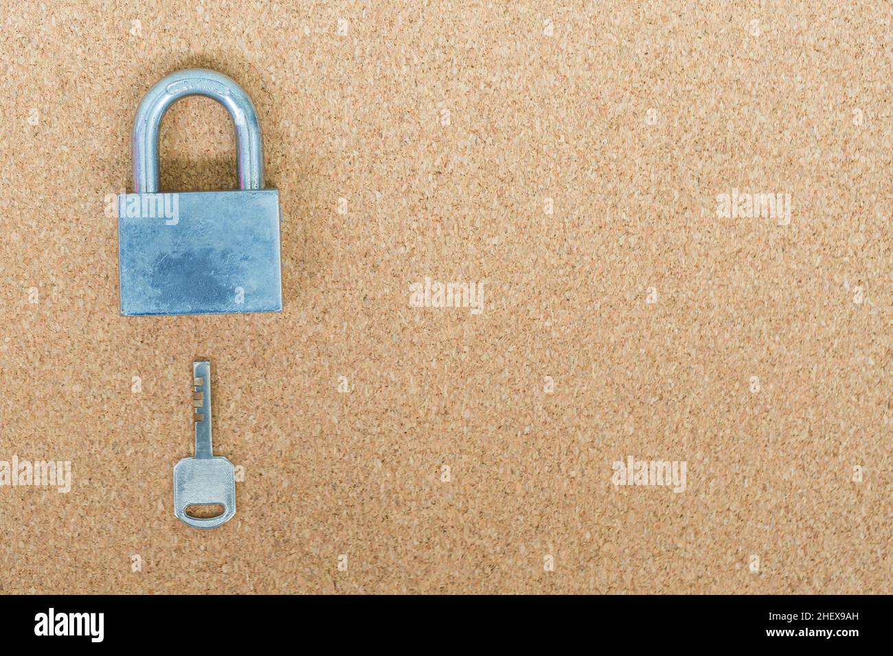 Old master key and key lock on cork board background Stock Photo - Alamy