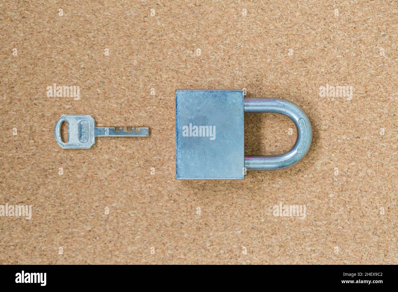 Old master key and key lock on cork board background Stock Photo - Alamy
