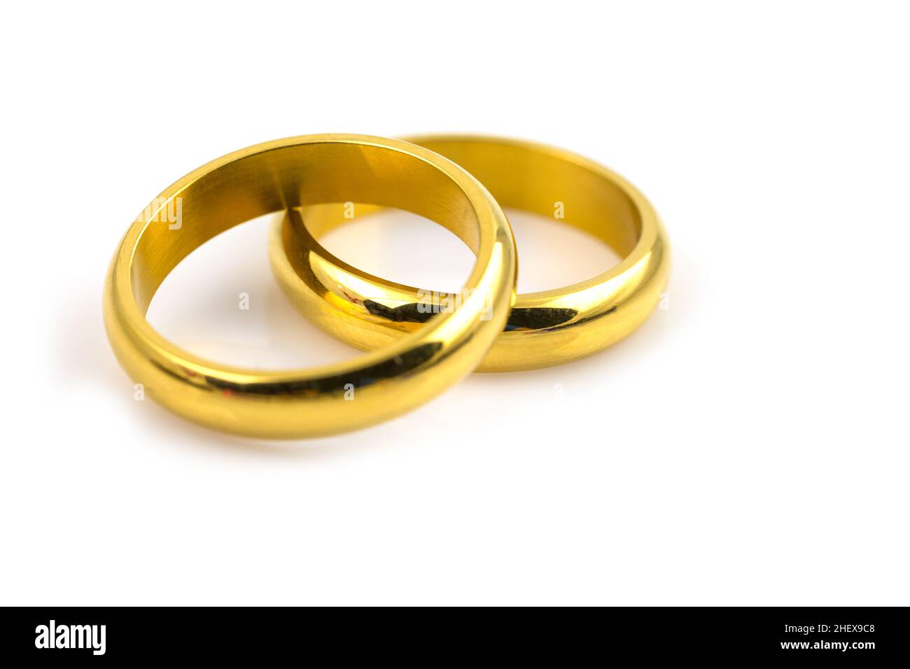 Close up of two gold rings for wedding isolated on white background ...