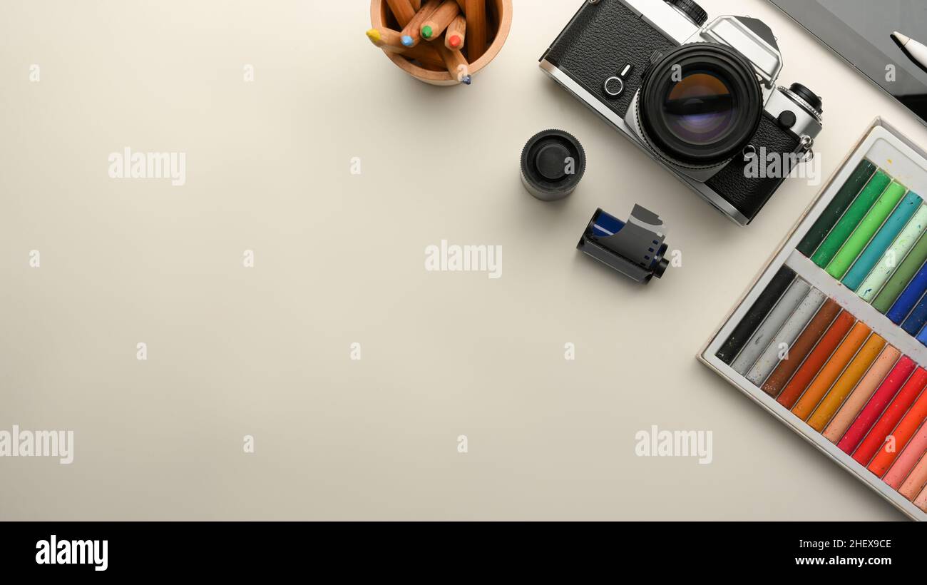 Graphic designer or photographer workspace with retro camera, film ...