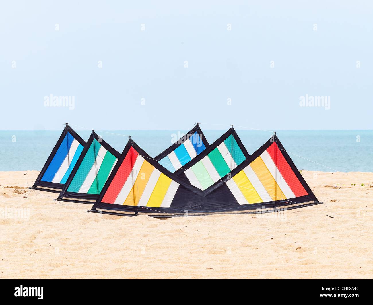 A stack of three quad line sports kites in red, green and blue colours ...