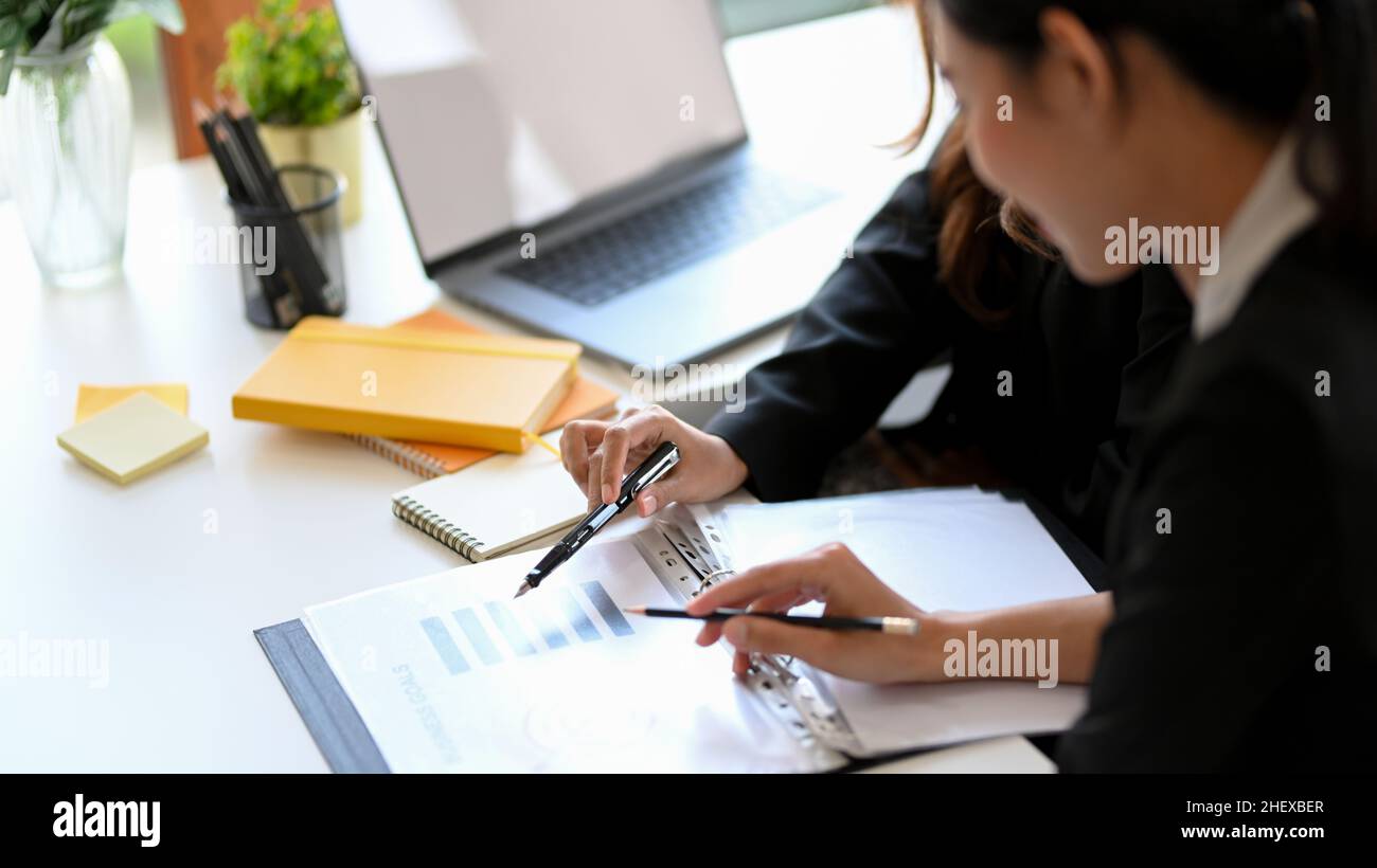 Close-up, A female financial boss briefing an assignment to her ...