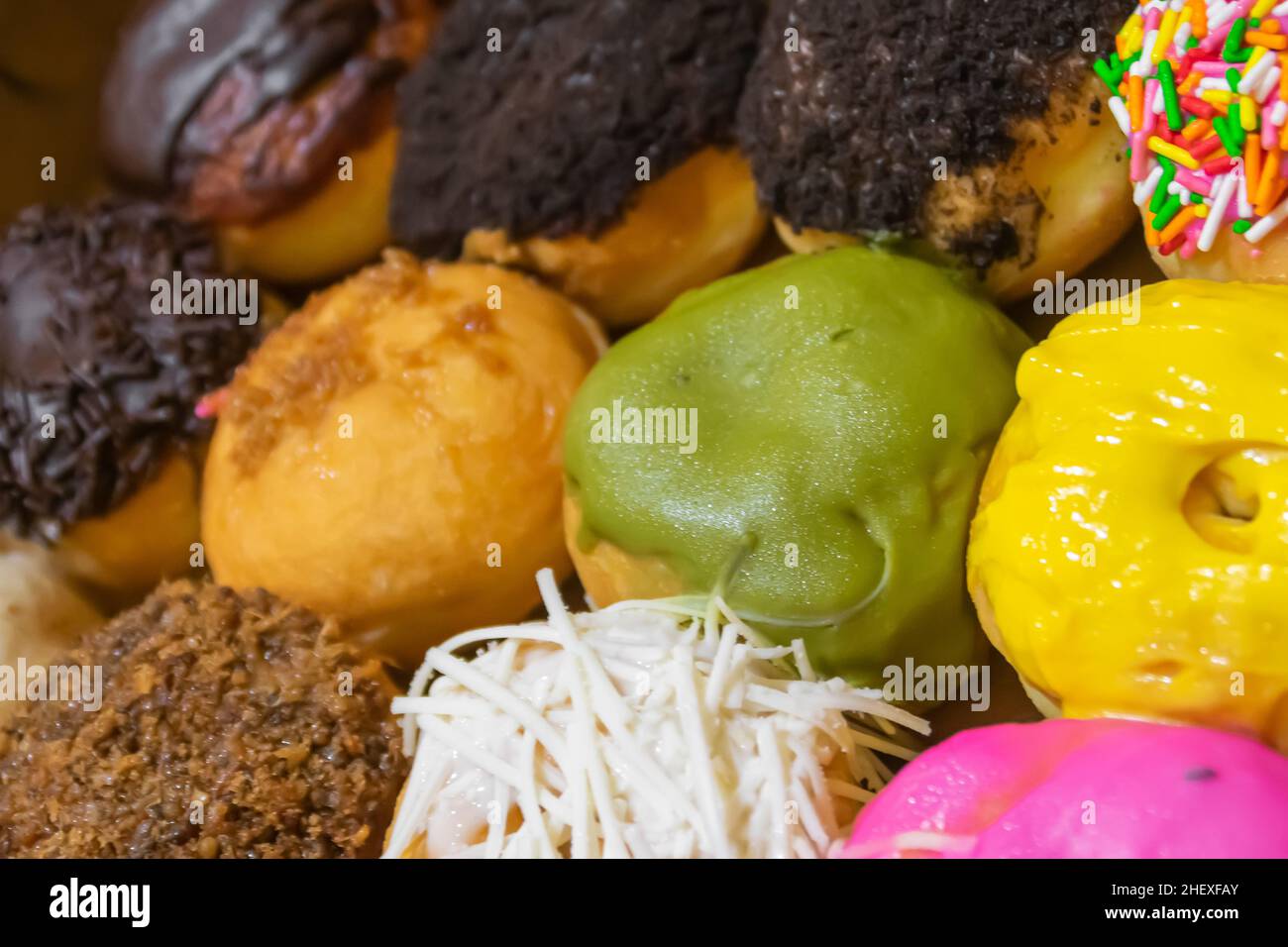 Row of delicious and tasty of donuts with assorted of colorful topping ...