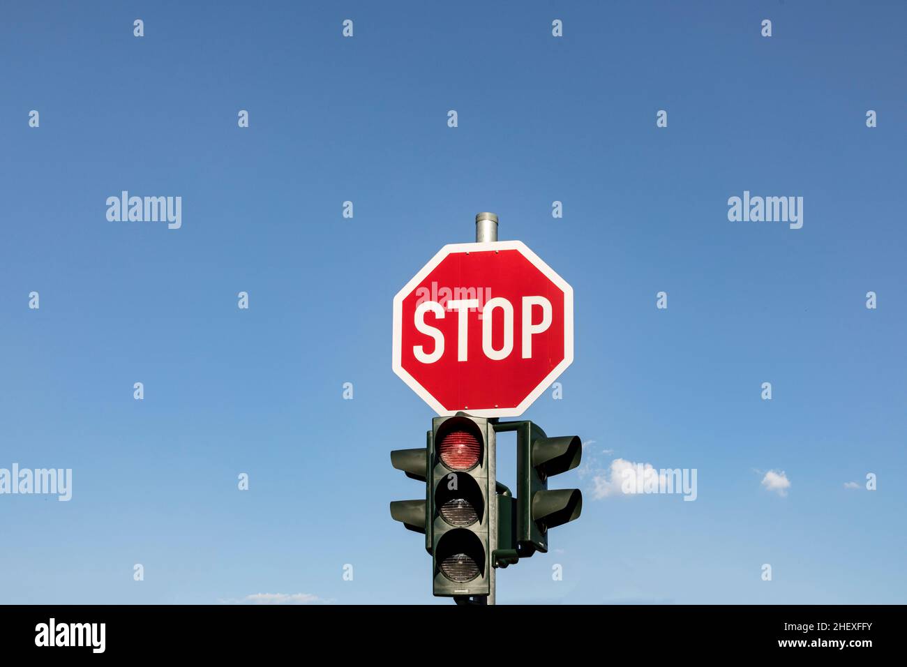 red traffic sign and stop sign under clear blue sky Stock Photo - Alamy