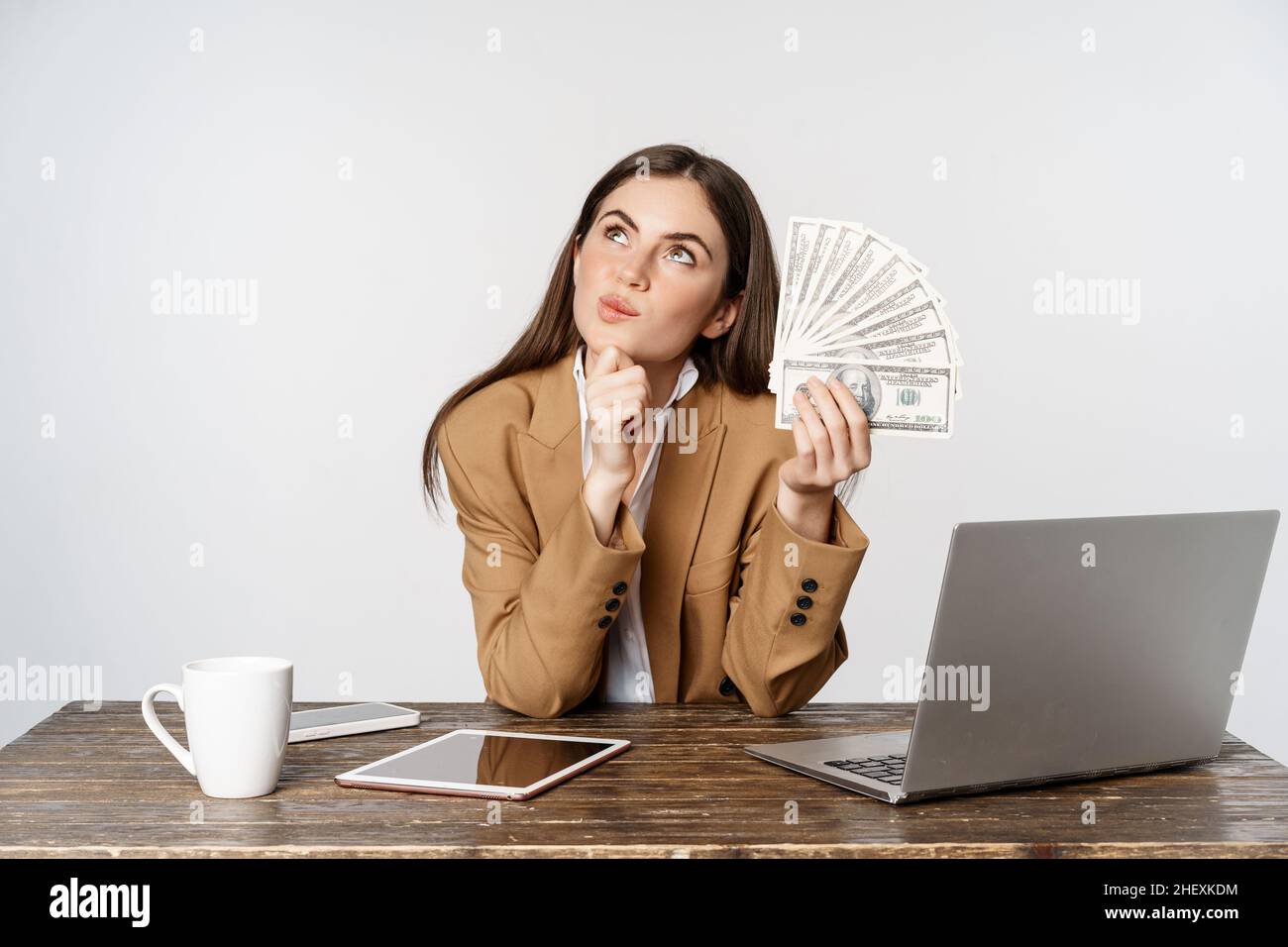 Portrait of businesswoman sitting in office with money, working and ...