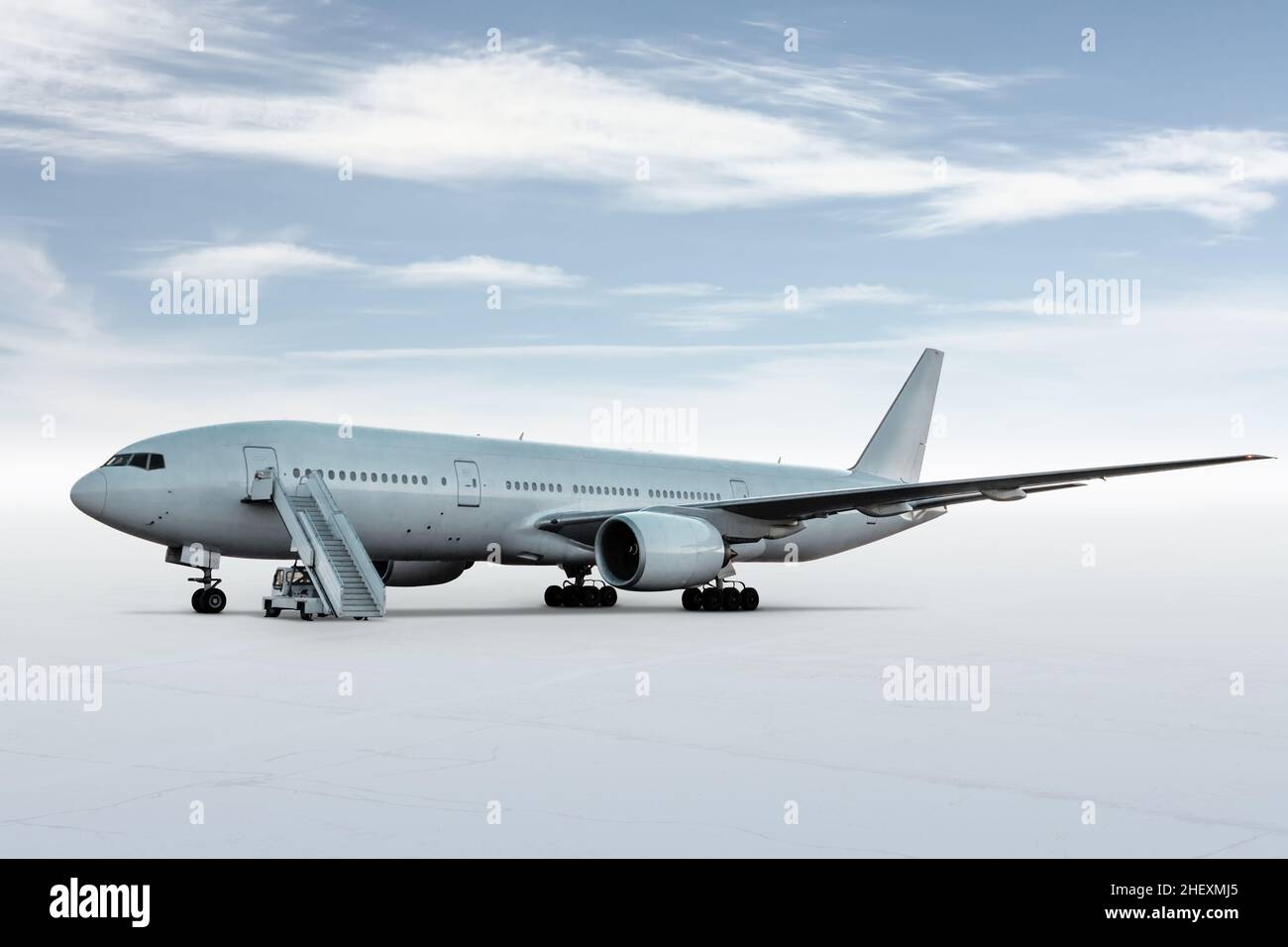 Wide body passenger airplane with a boarding steps isolated on bright ...
