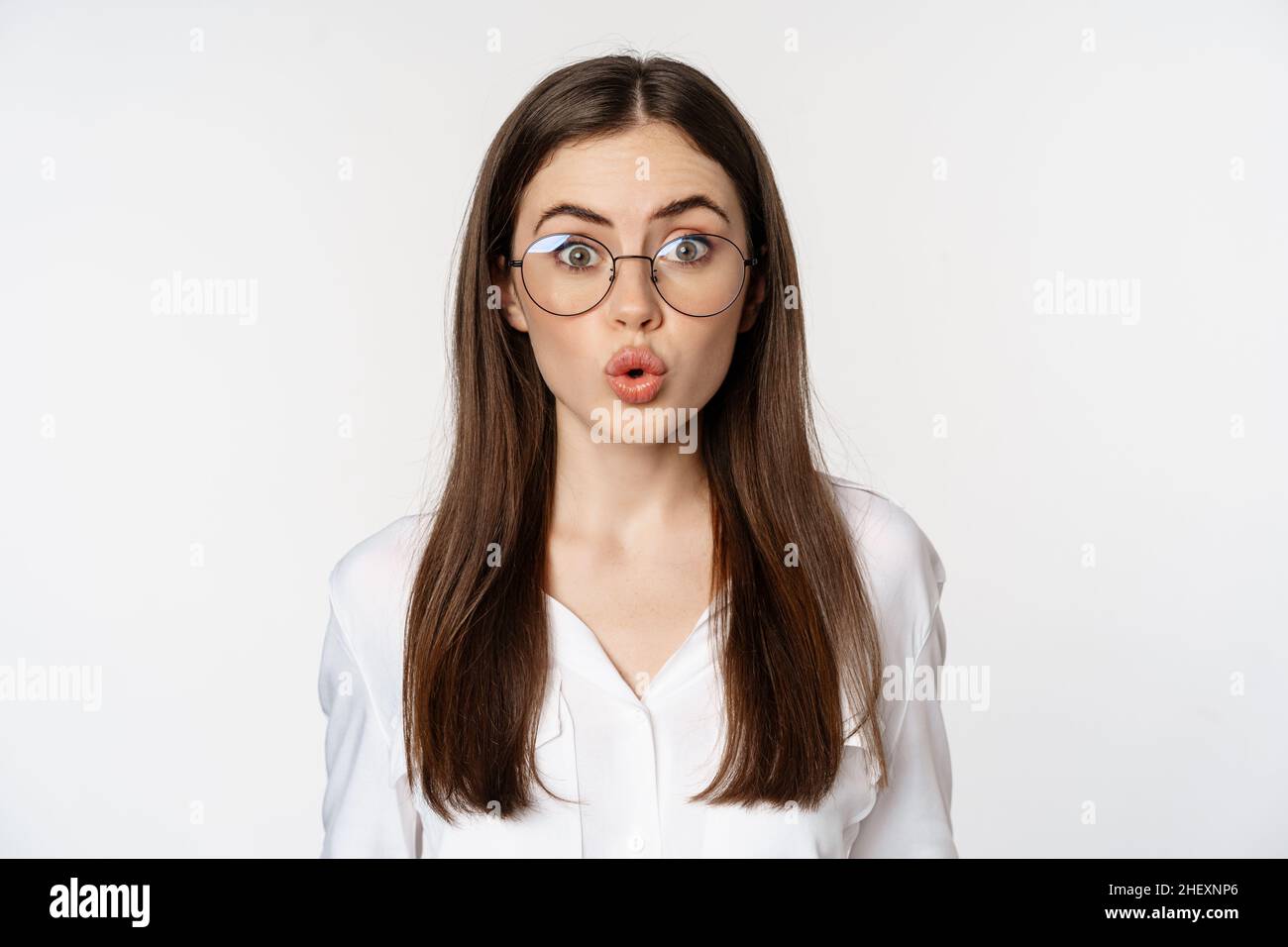 Close up portrait of corporate woman in glasses, looking surprised ...