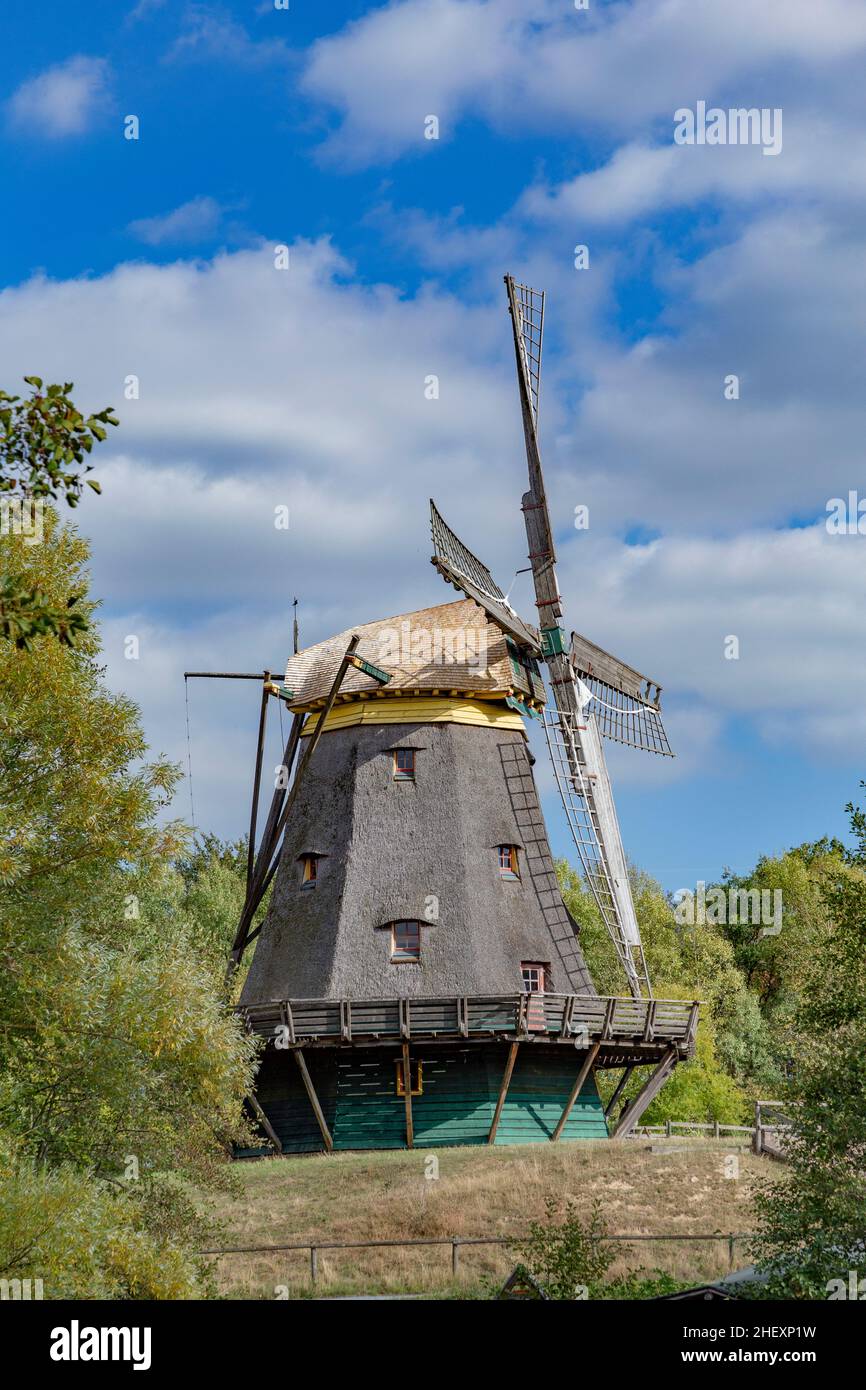 old wooden windmill under blue sky Stock Photo - Alamy