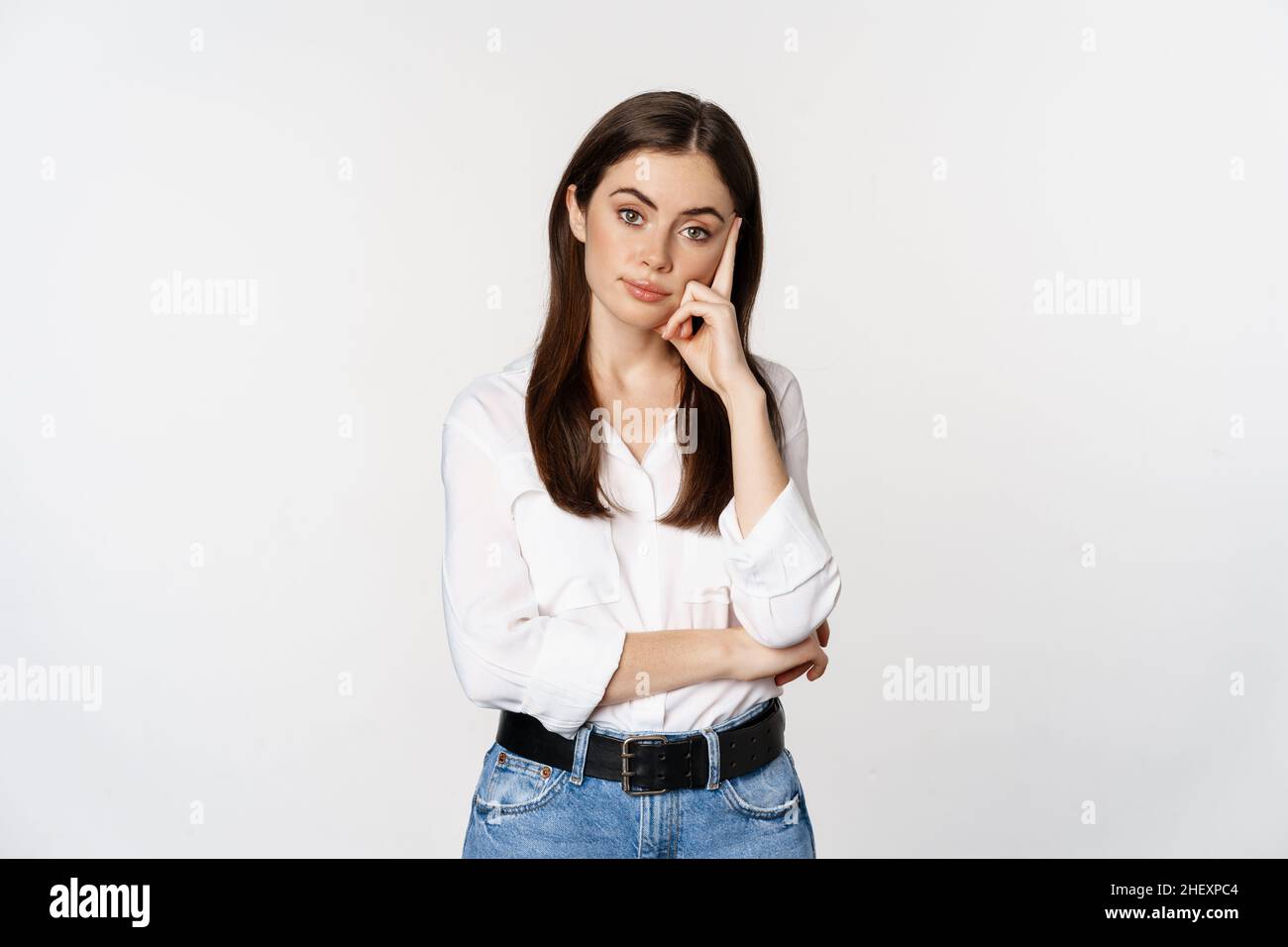 Unamused, bored brunette woman looking gloomy and sad, sighing ...