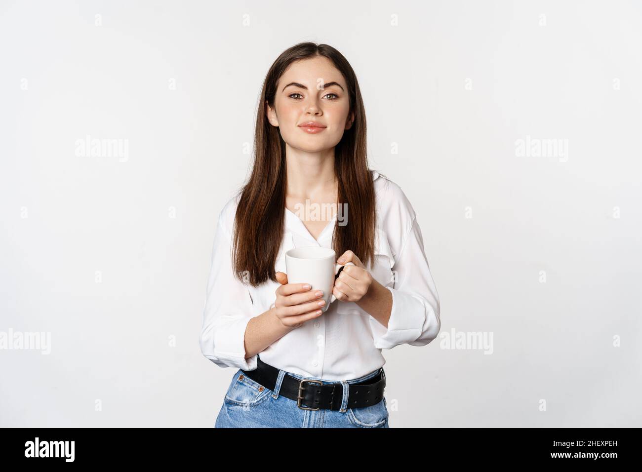 Young moder business woman, office lady holding mug with coffee tea and ...