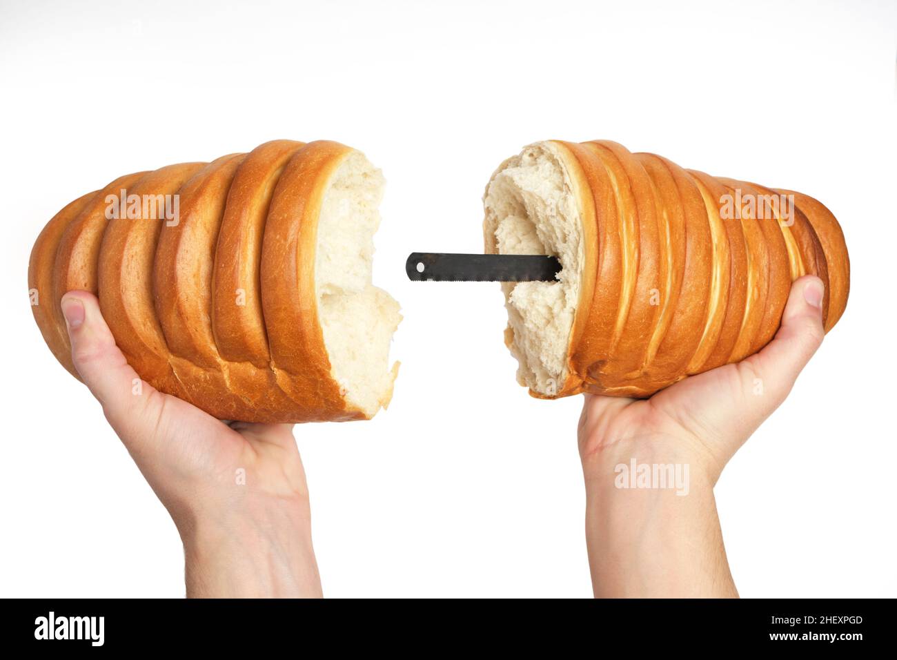 In hands loaf of bread, broken in half, with hacksaw metal inside.Tool ...