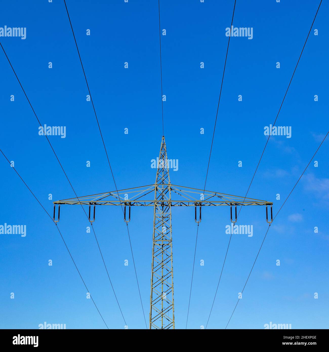 electric pylon under clear blue sky Stock Photo - Alamy