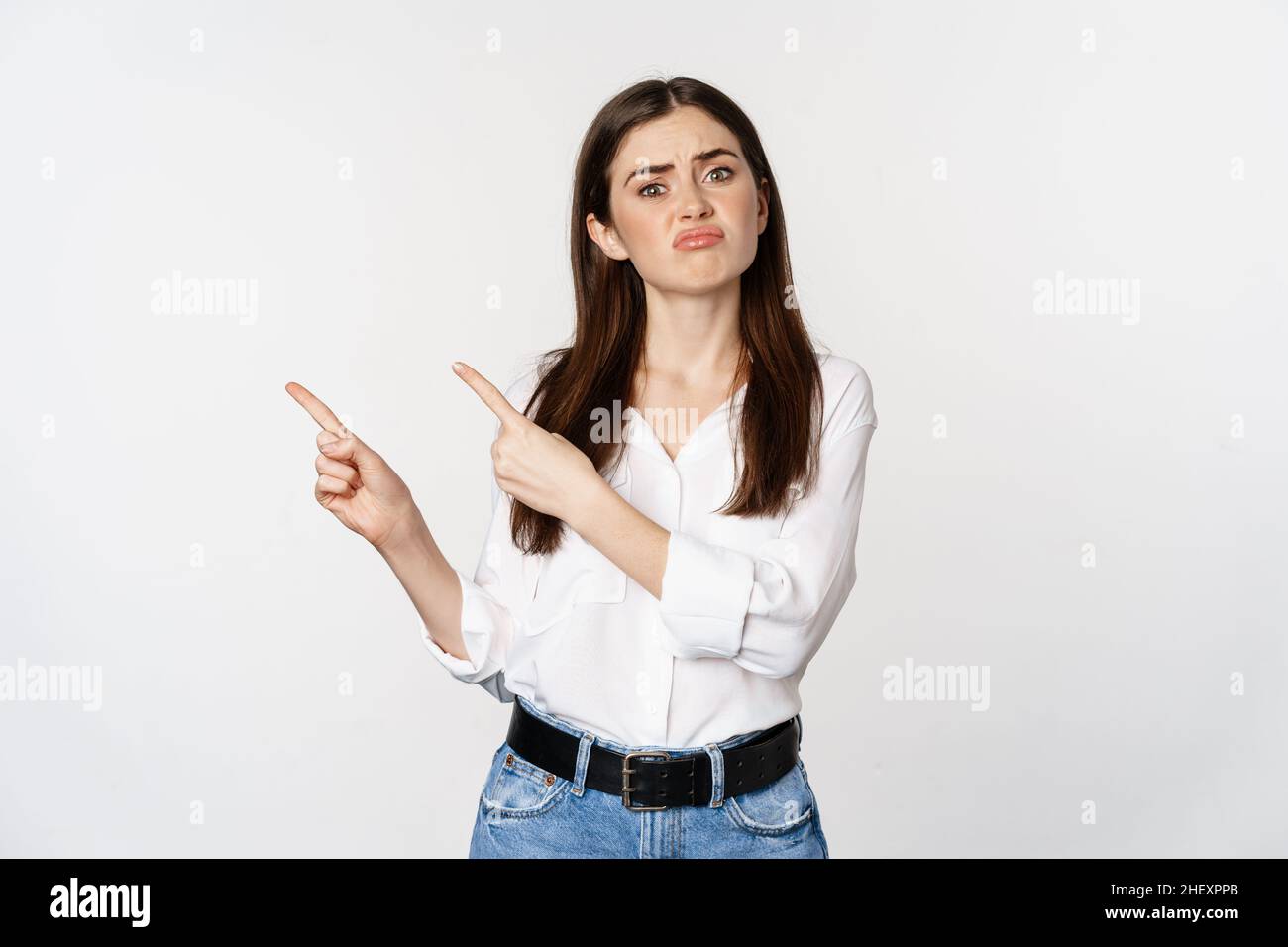 Sad and disappointed cute woman, gloomy girl pointing fingers at logo ...