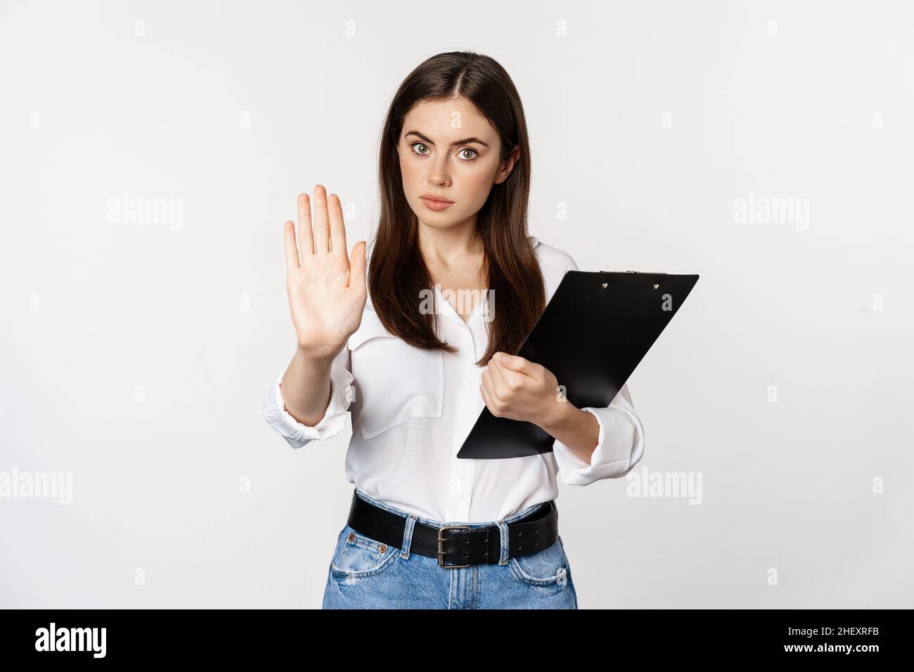 Serious woman with clipboard documents, extending arm, showing taboo ...
