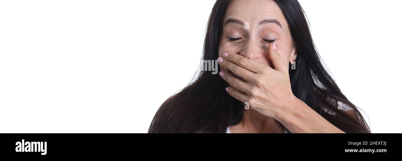 Portrait of woman covering hand over mouth on white background Stock ...