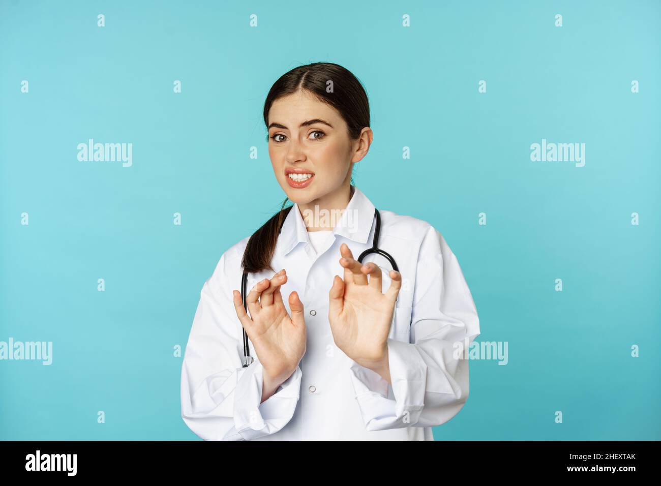 Image of woman doctor cringe, looking with dislike or aversion ...