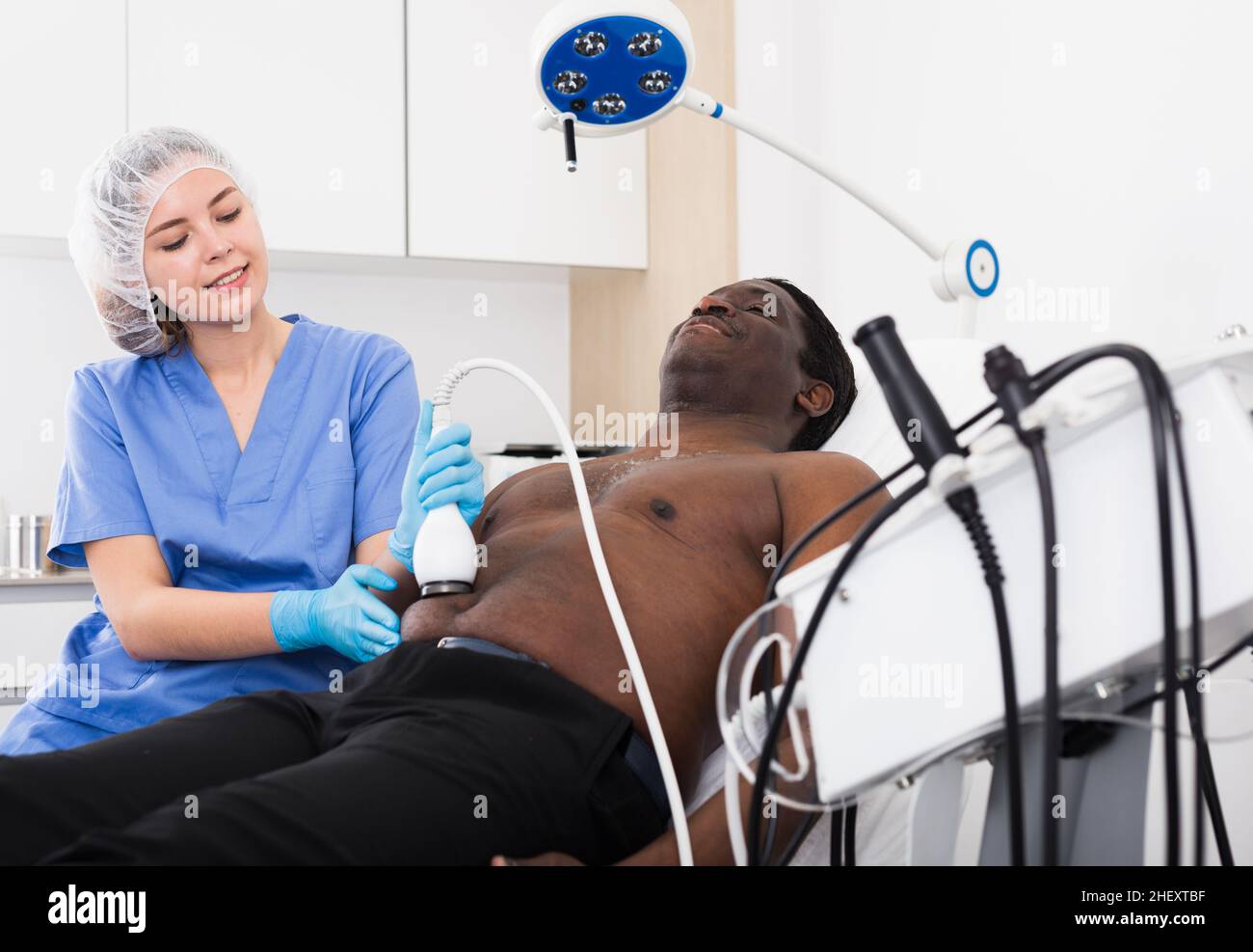 Afro american man having cavitation procedure in beauty clinic Stock ...