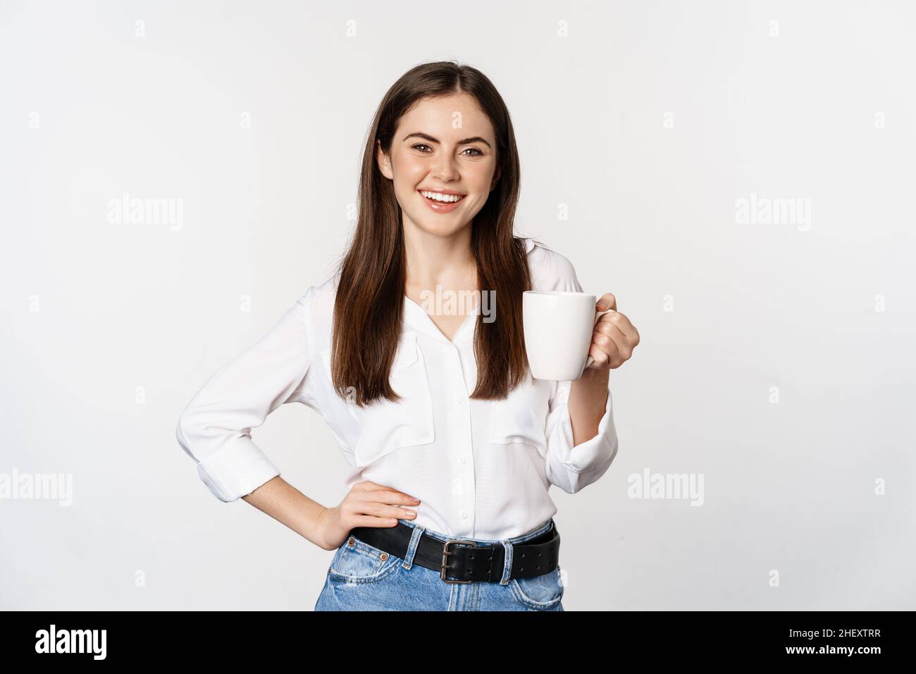Young moder business woman, office lady holding mug with coffee tea and ...
