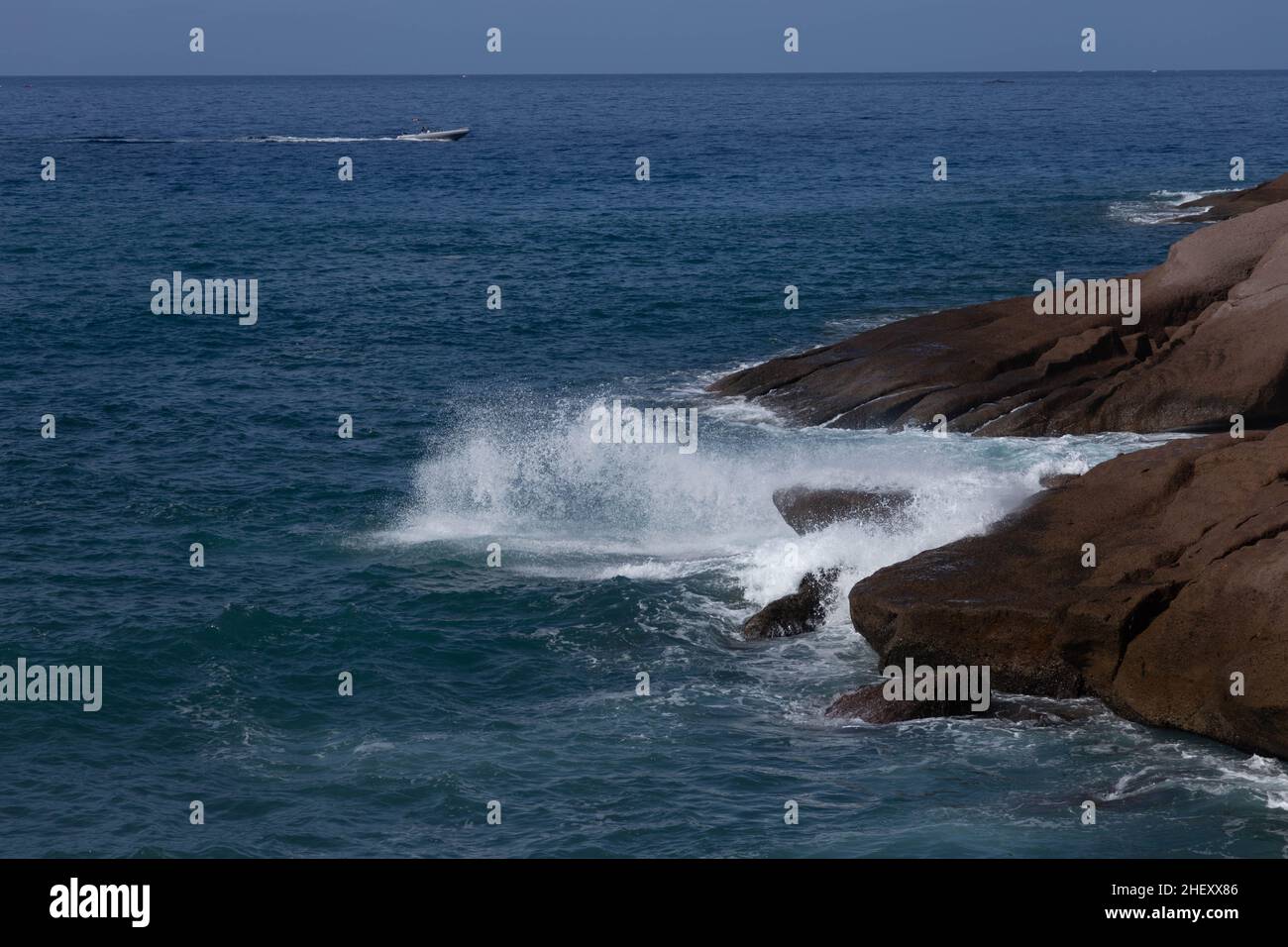 The waves of the Atlantic Ocean crash on rocks with splashes in ...
