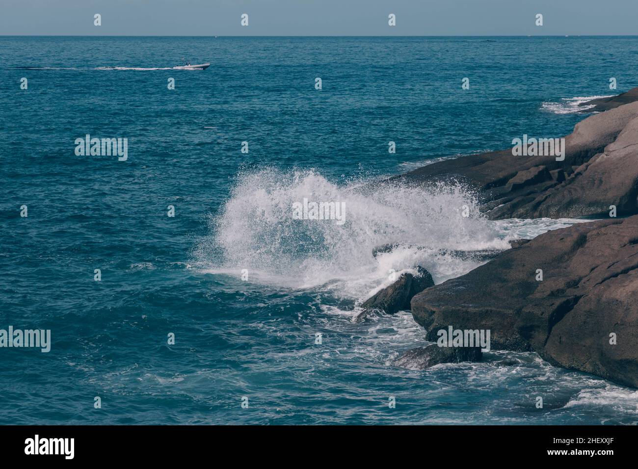 The waves of the Atlantic Ocean crash on rocks with splashes in ...