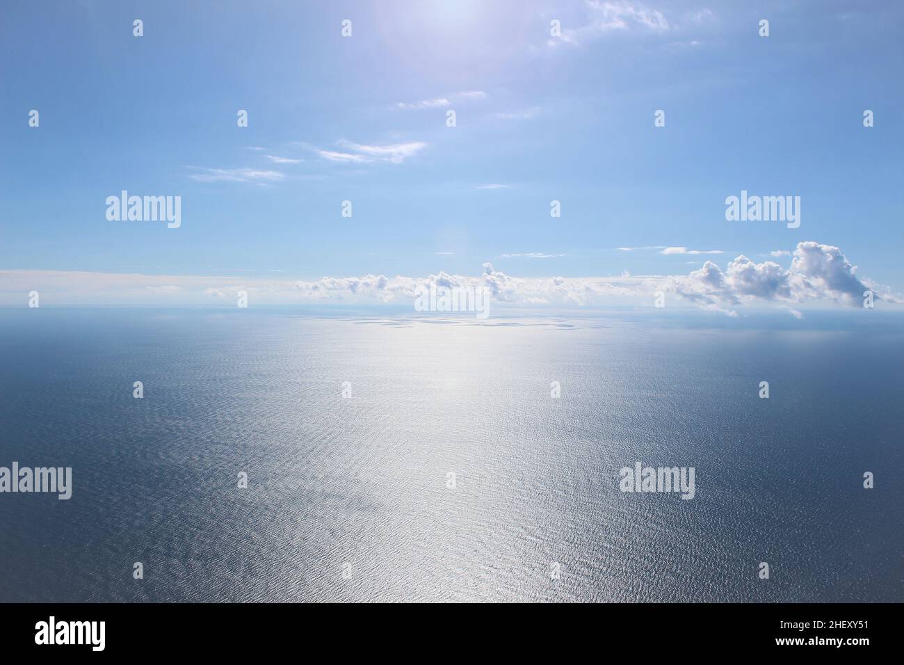 Aerial landscape of the sea surface and blue sky with clouds. Beautiful ...