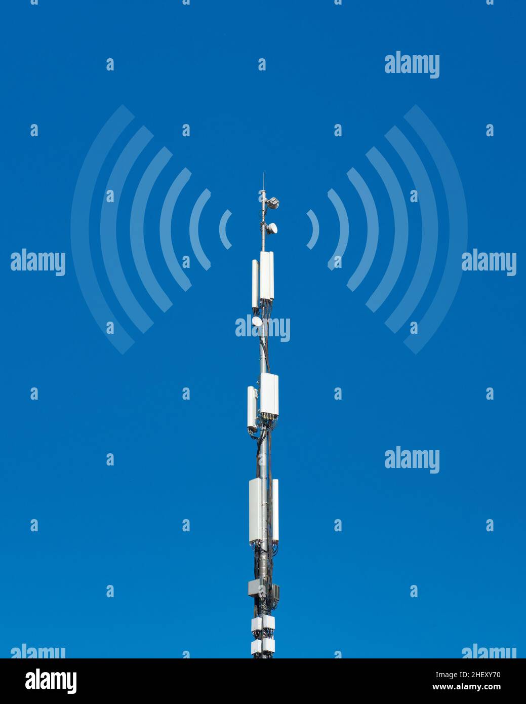 Telecommunication cell tower antenna against blue sky background. Wireless communication and ...