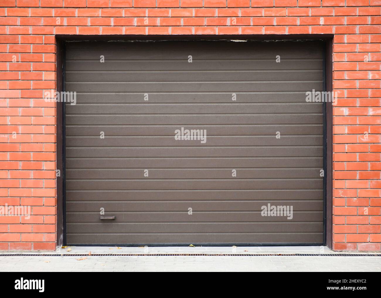 Modern automatic lifting gates on the brick wall of garage Stock Photo ...
