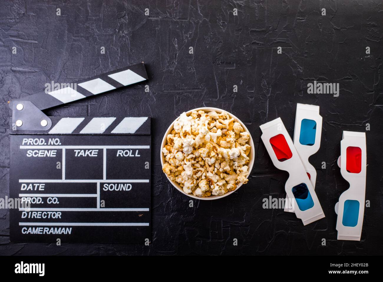 Cinema minimal concept. popcorn, 3d glasses clapper board on black ...