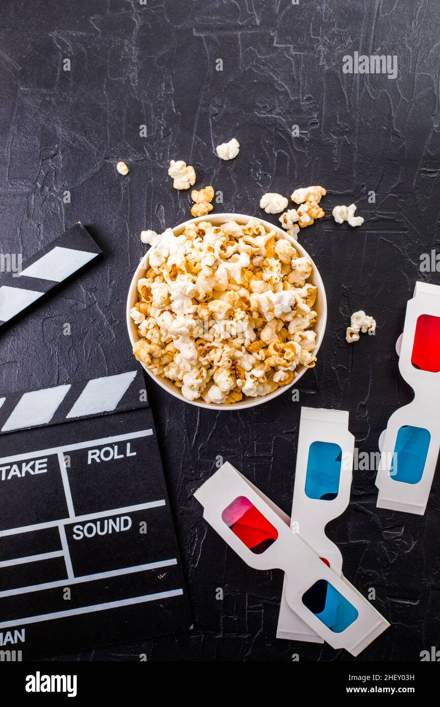 Cinema minimal concept. popcorn, 3d glasses clapper board on black ...