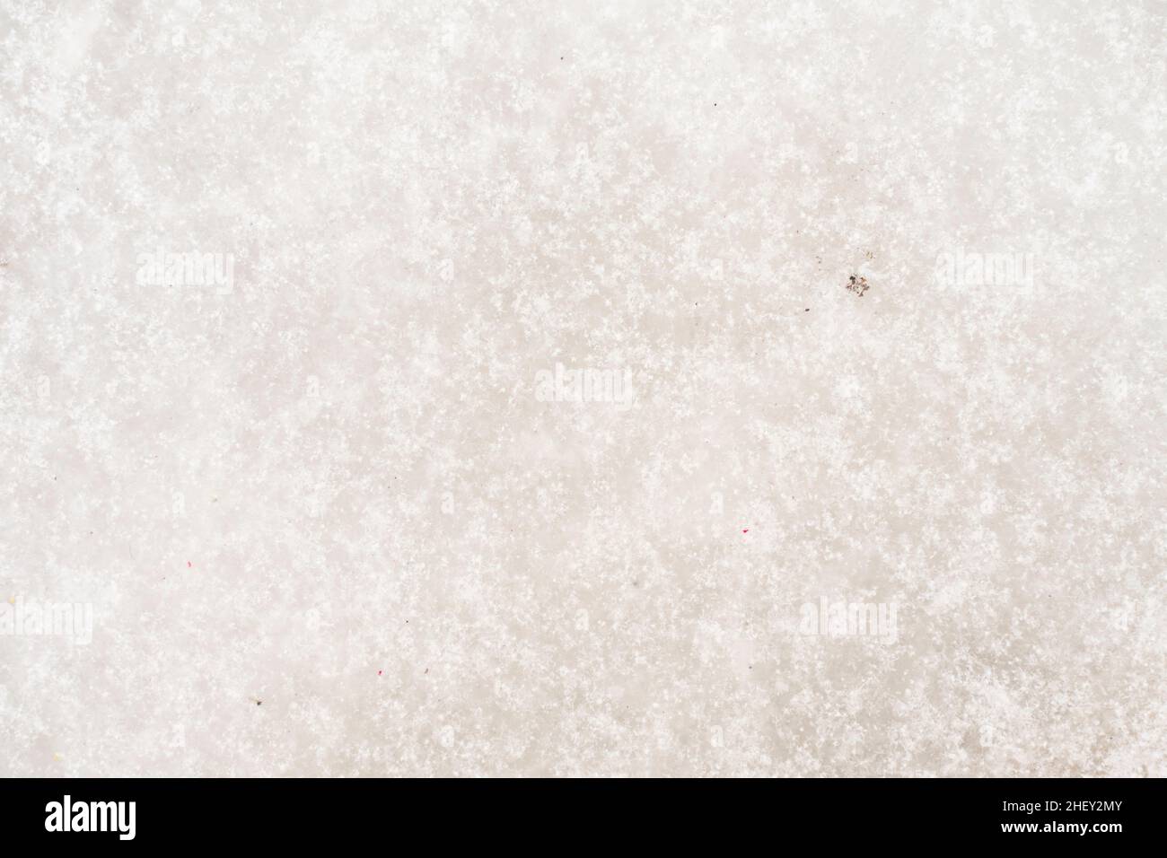 ice surface covered with snow, winter texture Stock Photo - Alamy