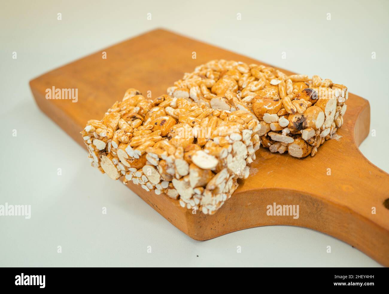 Close up photo of bread and puff rice over the wooden board with white ...