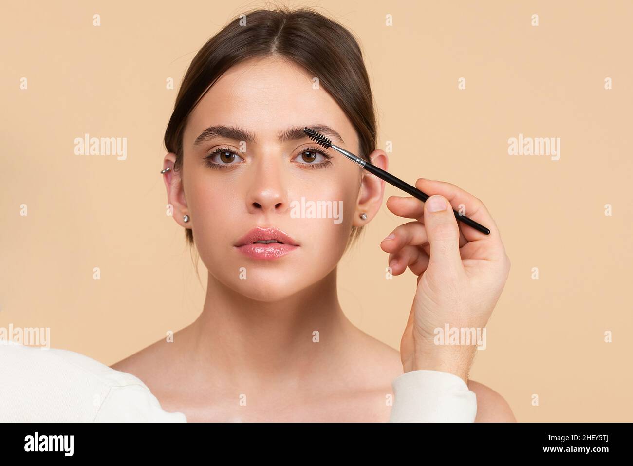 Woman eye with beautiful eyebrows. Perfect shaped brow, eyelashes with brow gel brush. Female ...