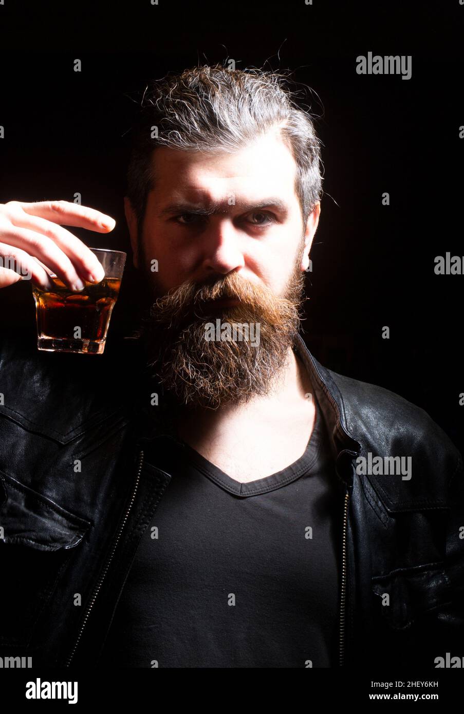 Man drinking whiskey, brandy, cognac. Man with glass of brandy. Bearded ...