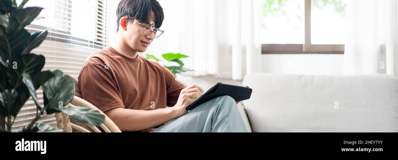 Technology Concept The young man who is sitting on the chair holding ...
