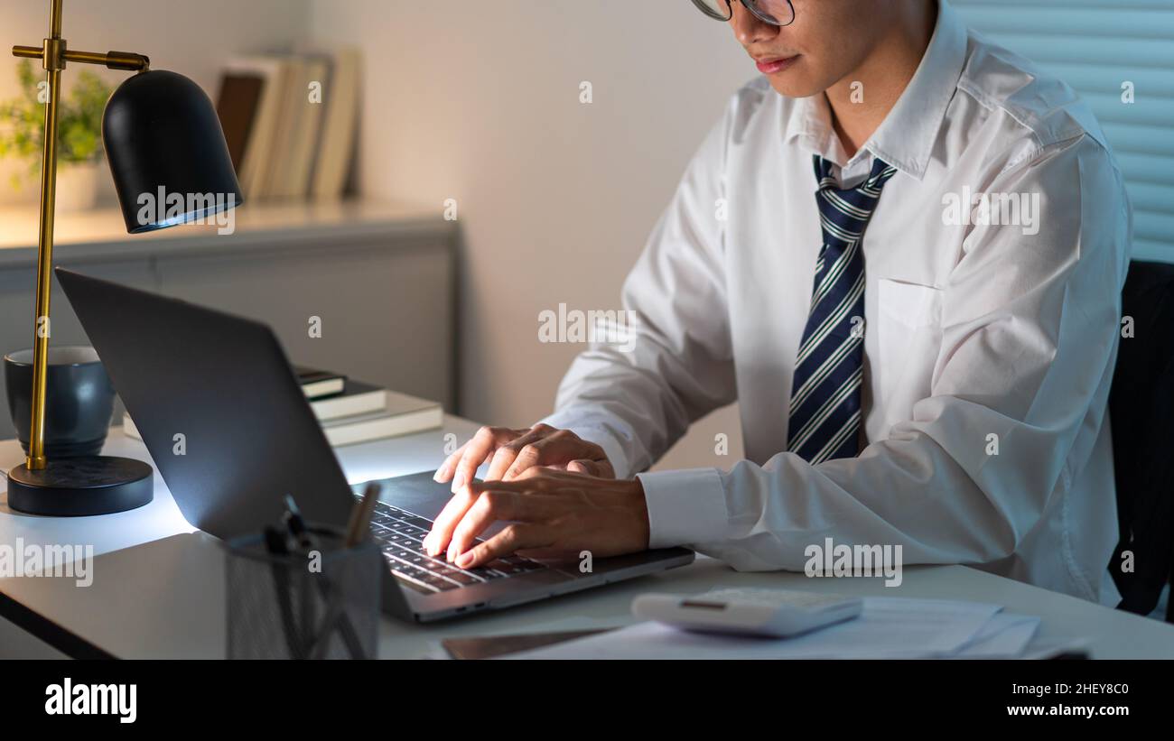 Overwork Concept The man sitting at his desk and focusing on working ...