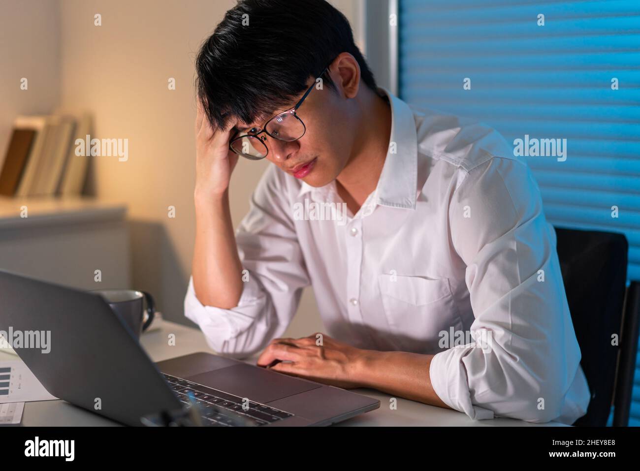 Overwork Concept The male officer resting his forehead on his right ...