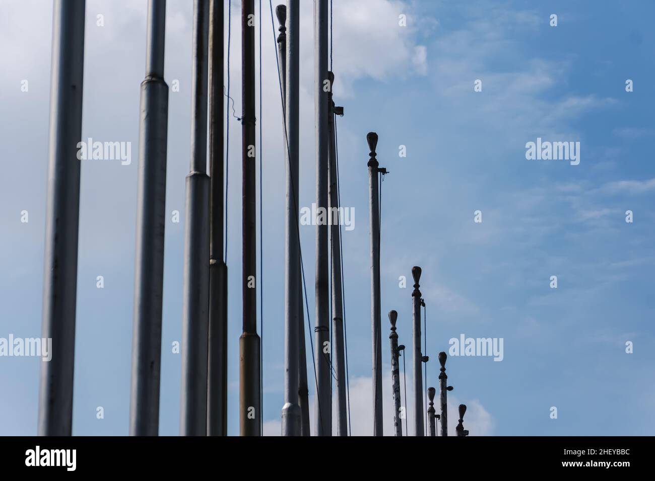 Line of empty flag poles make an arrangement under the scenic and ...