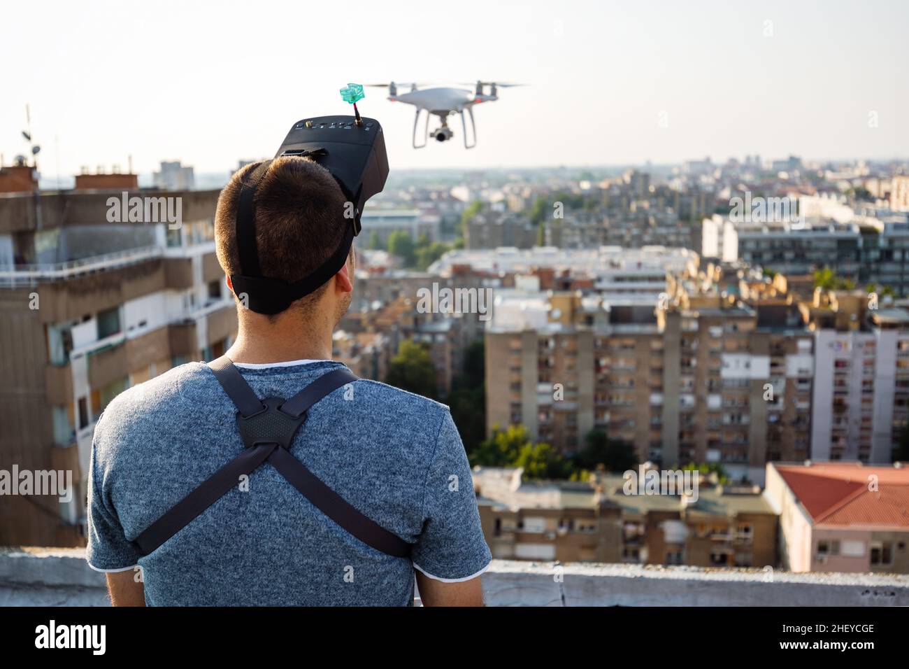 Young technician man flying UAV drone with remote control in city Stock ...