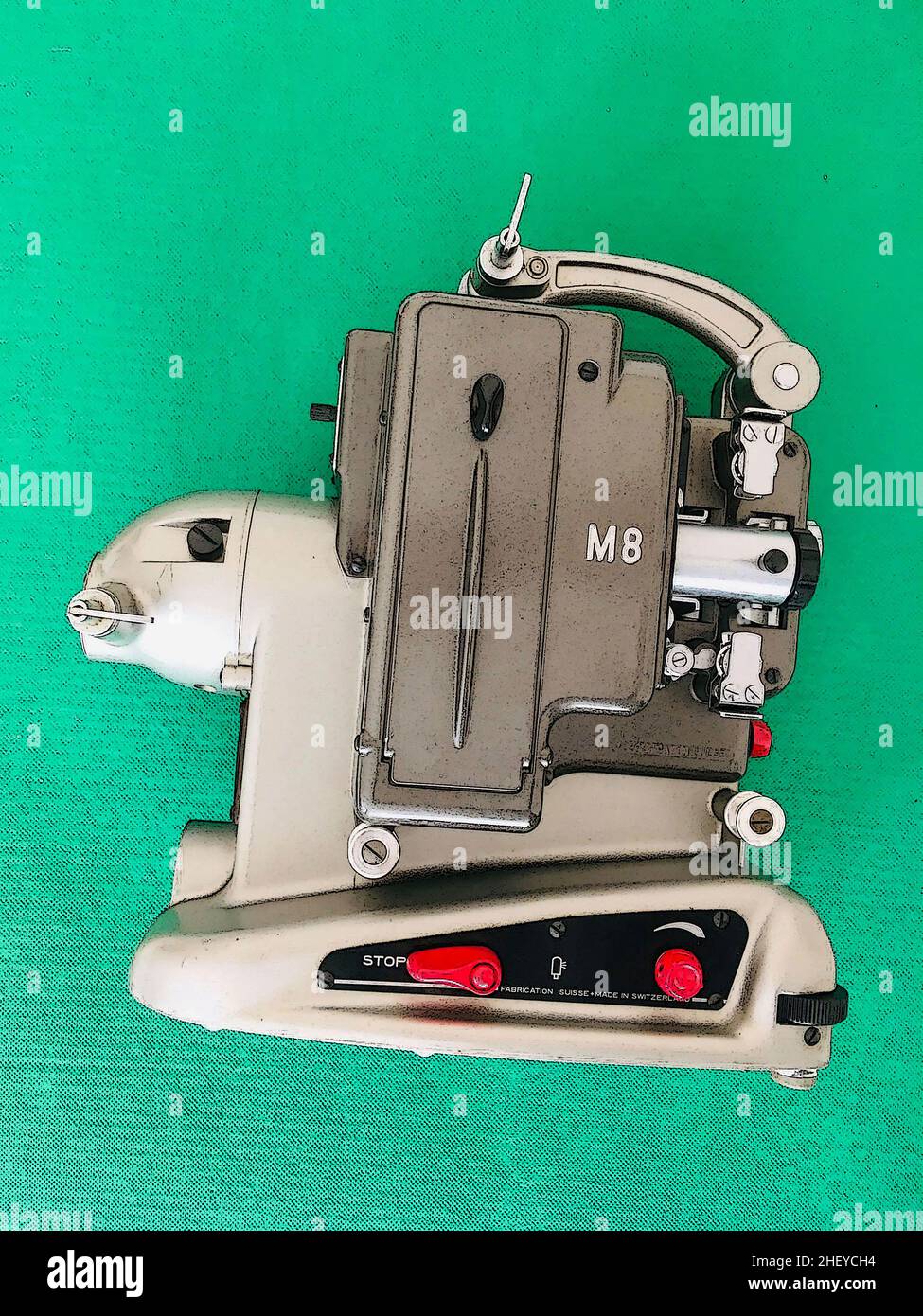 High contrast side view of a vintage 8mm home movie projector on a ...