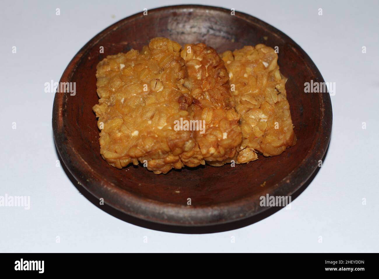 Fried Fermented Soybean Cakes or tempeh. Placed on a clay bowl. This is ...