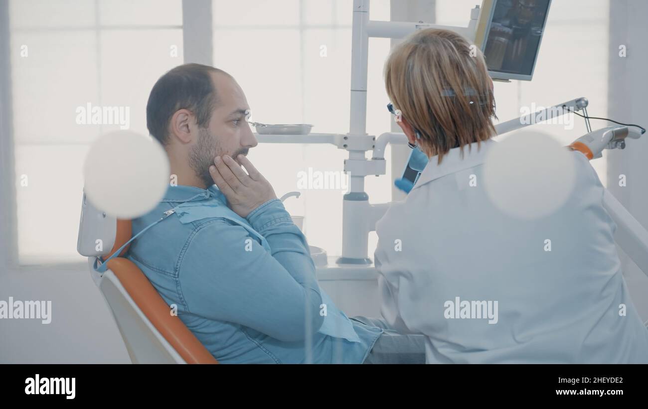 Dentist and patient talking about teeth radiography scan at ...