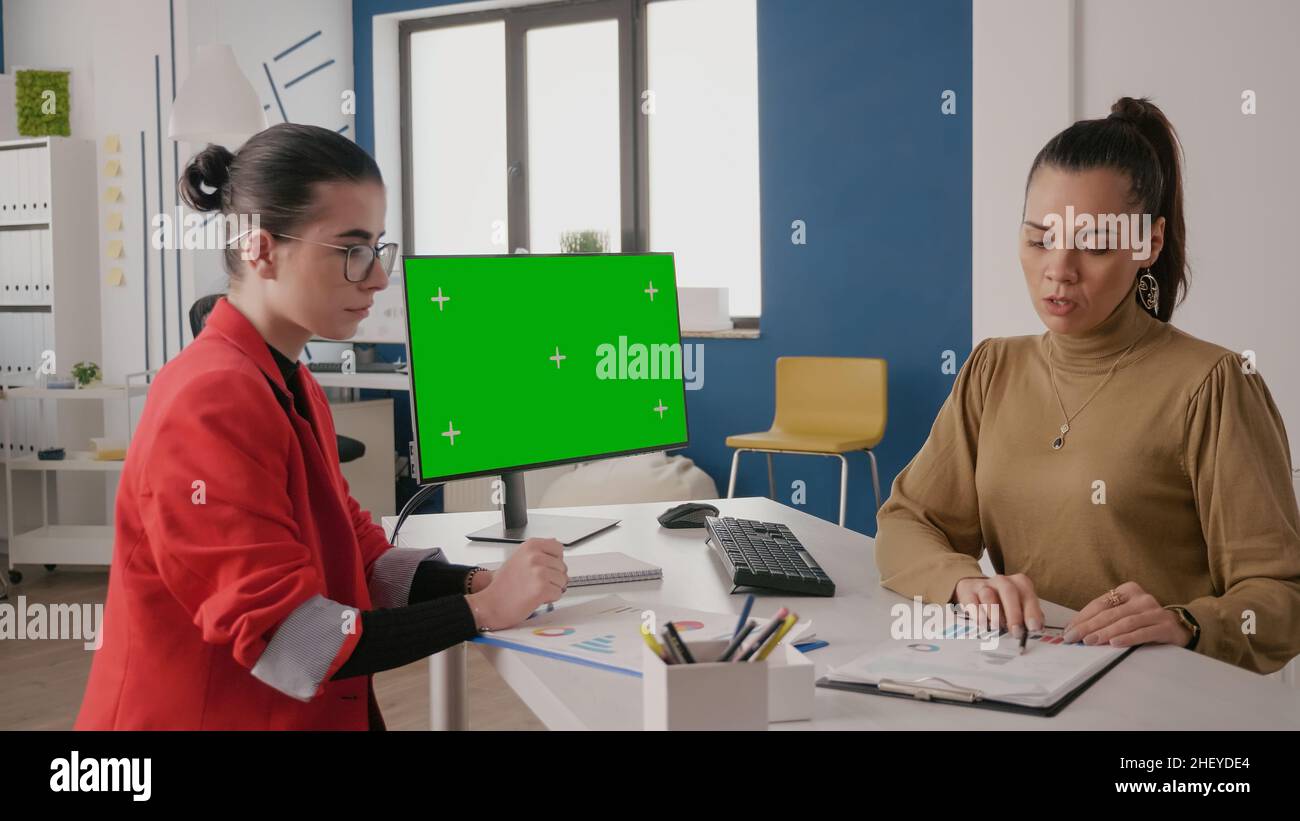 Women working together with green screen on computer. Colleagues having ...