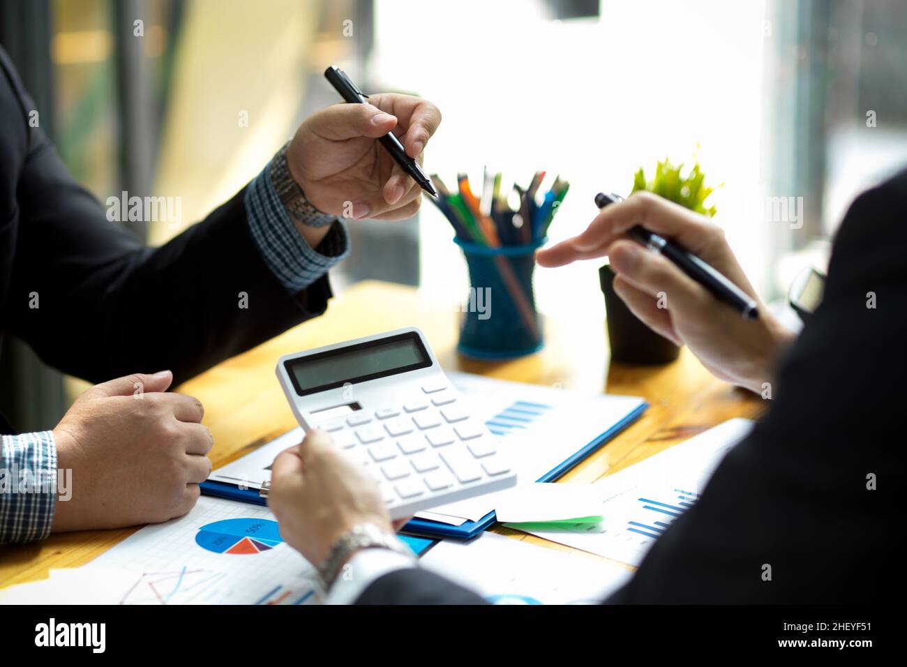 Male financial consultant talking about their business financial plans ...