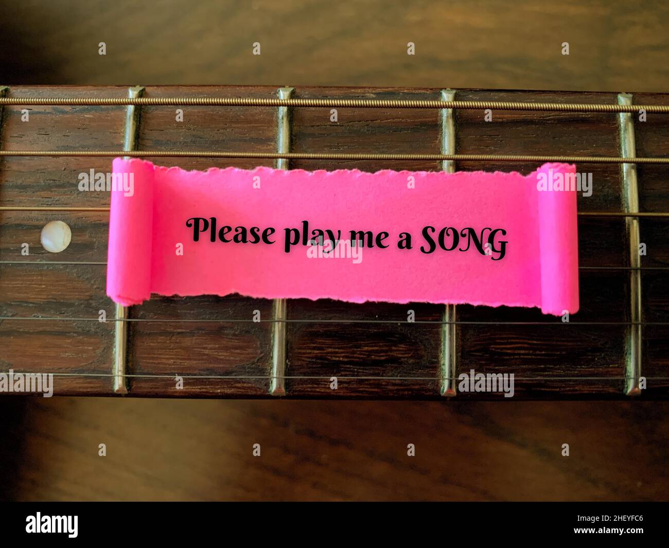 Please play me a song text written on a small piece of torn paper with ...