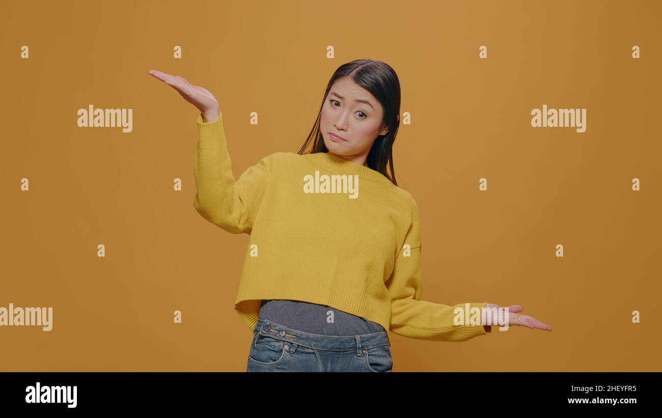 Pensive adult pondering answer and feeling uncertain in studio. Person ...